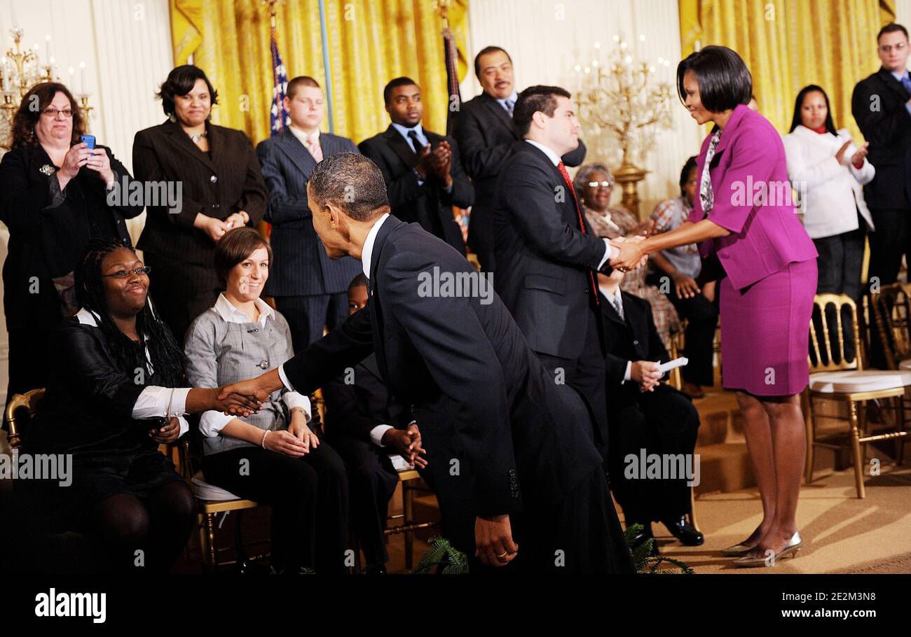 President Barack Obama and First Lady Michelle Obama greet guests at an ...