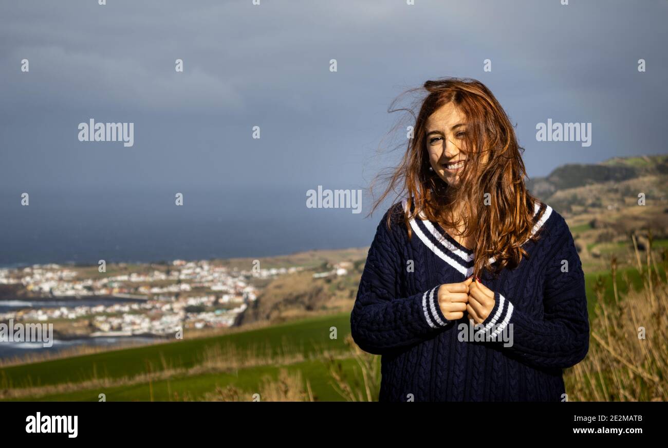 Authentic smiling young woman outdoors, in Mosteiros village, at São ...