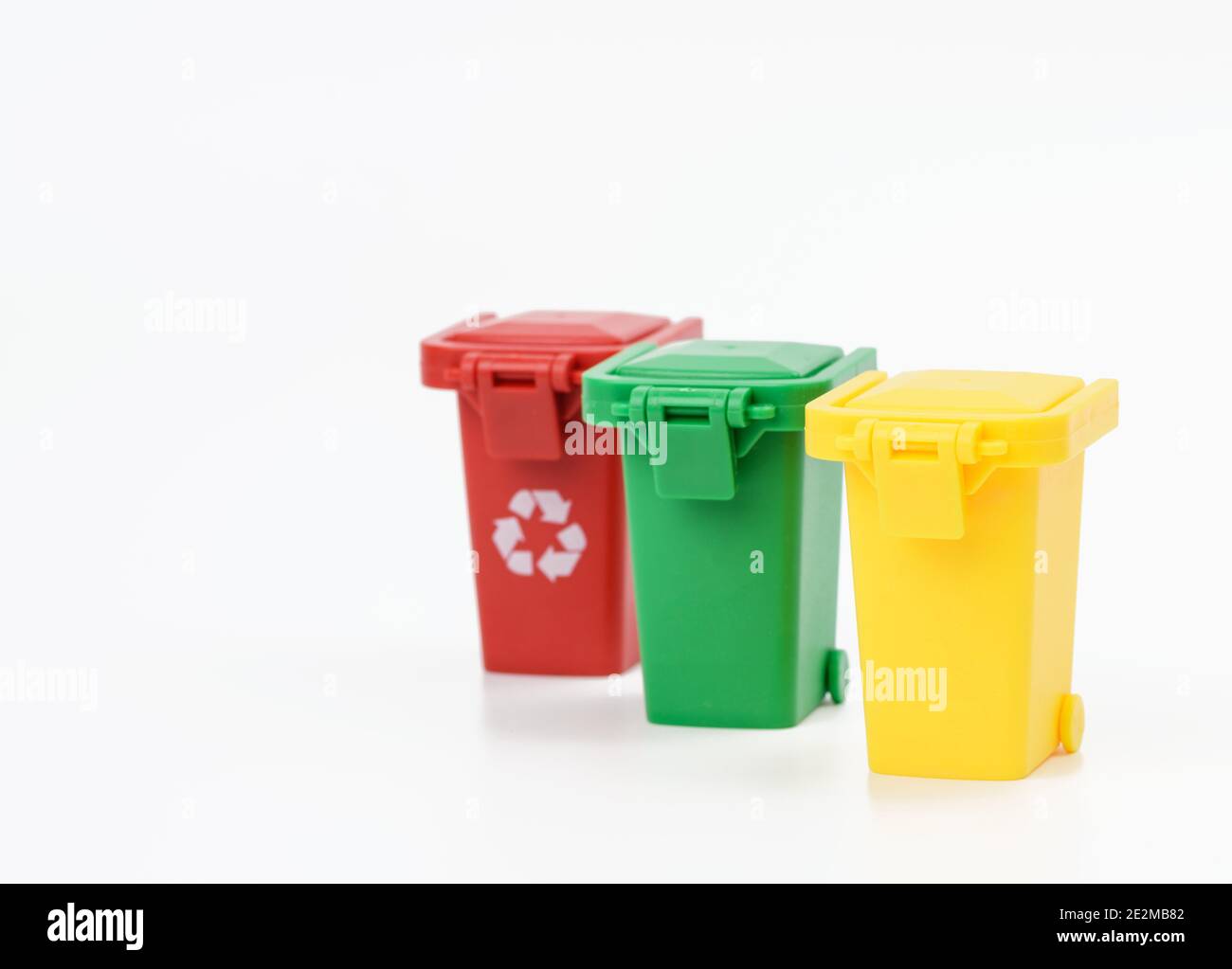 red, yellow and green plastic waste sorting container on white ...