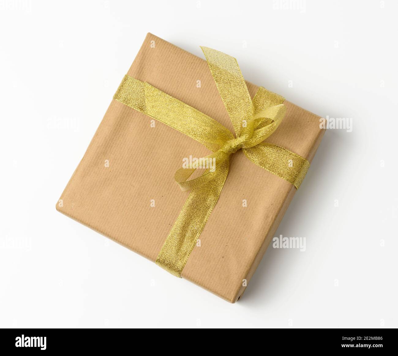 box wrapped in brown kraft paper and tied with golen ribbon, gift on ...