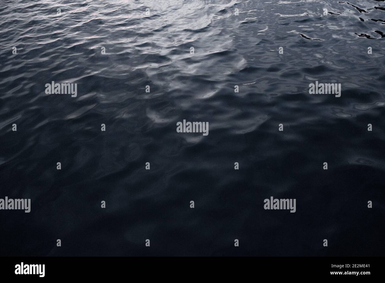 Abstract dark blue calm wavy water surface background Stock Photo - Alamy