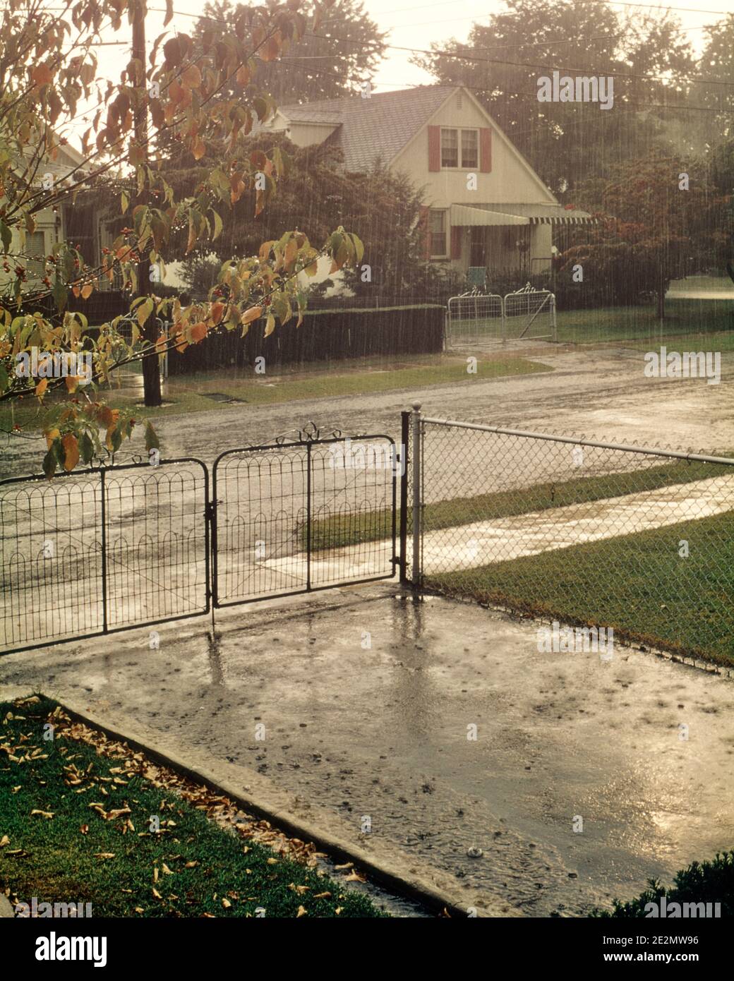 1970s FRONT LAWN DRIVEWAY STREET GATE HOUSES RAIN RAINING RAINY DAY ...