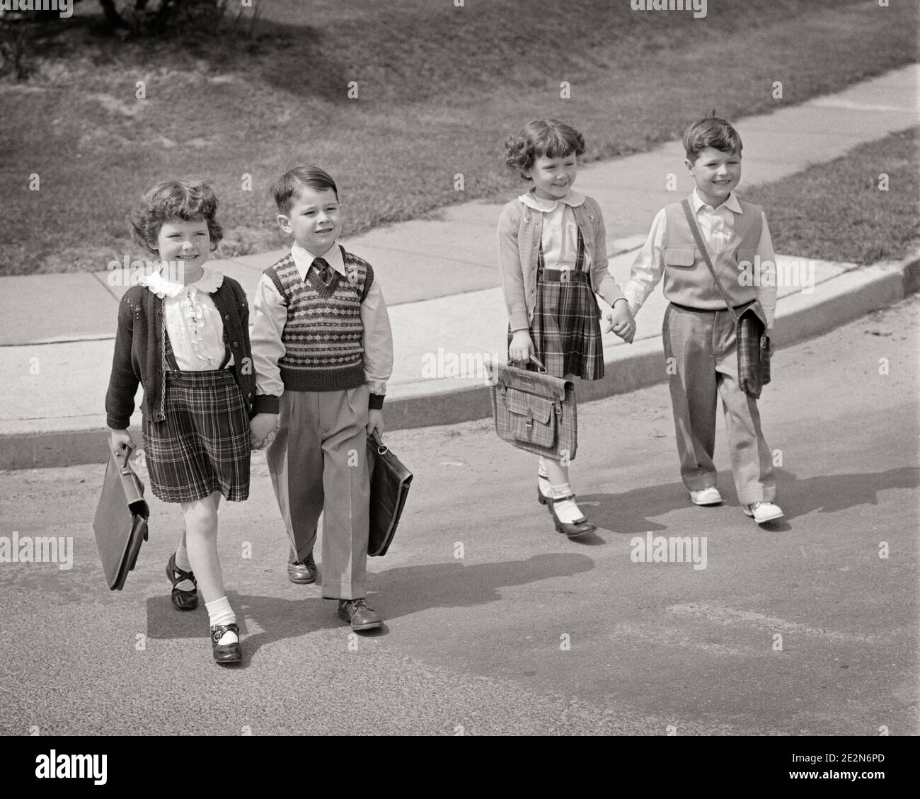 1950s FOUR CHILDREN BOYS AND GIRLS CROSSING STREET ON THEIR WAY TO ...