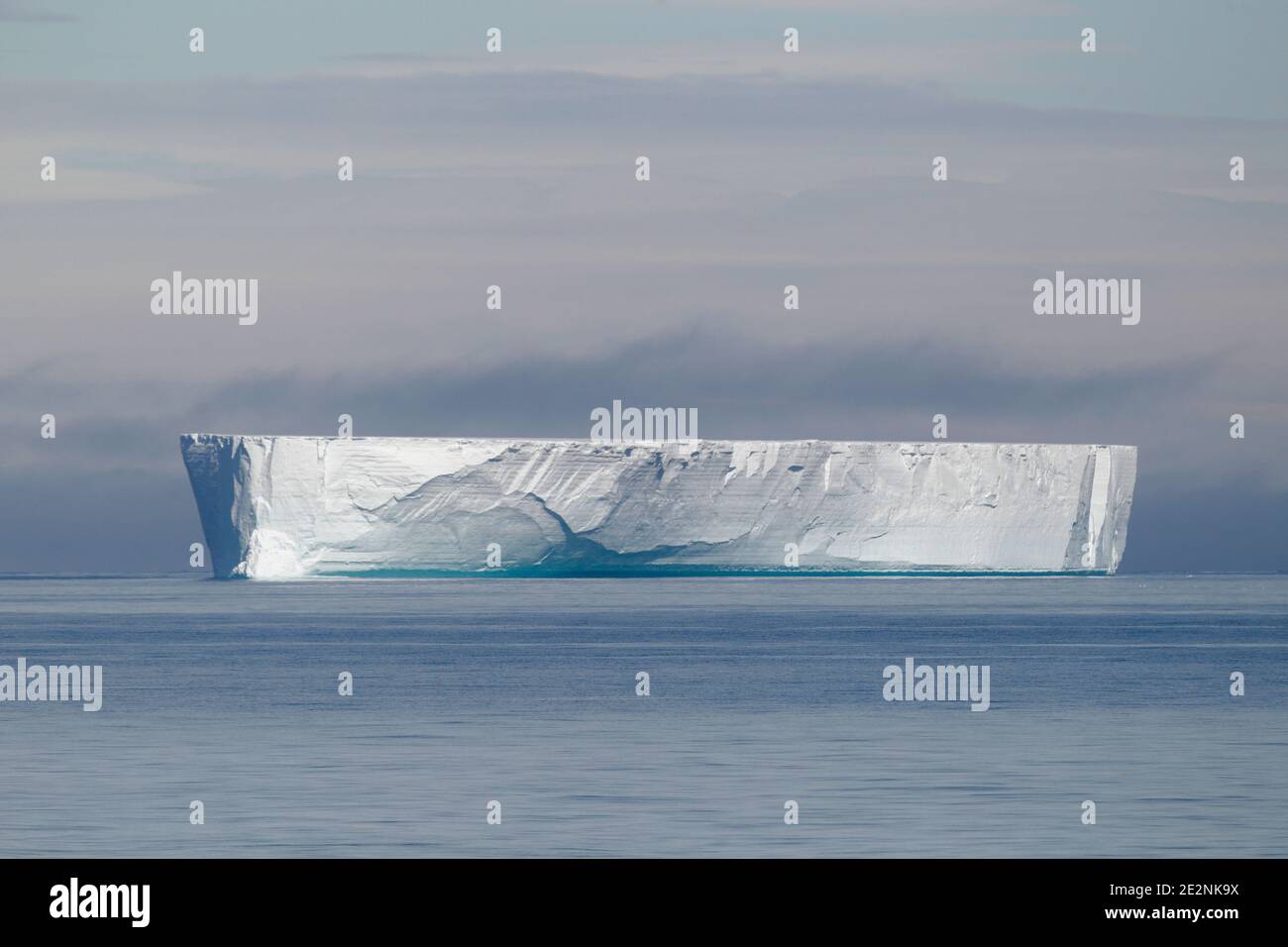 Horizontal view of flat piece of broken ice sheet, floating on calm ...