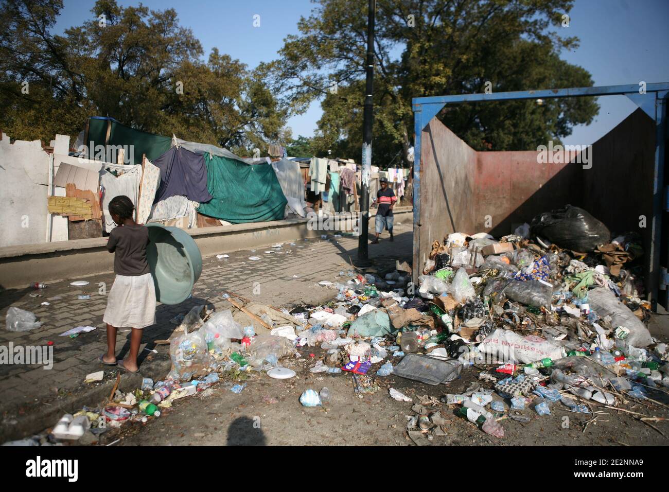 A girl just threw the garbage outside the Champ-de-Mars refugee camp in ...