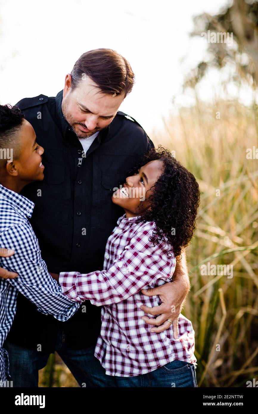 Father & Sons Embracing at Park in Chula Vista Stock Photo - Alamy
