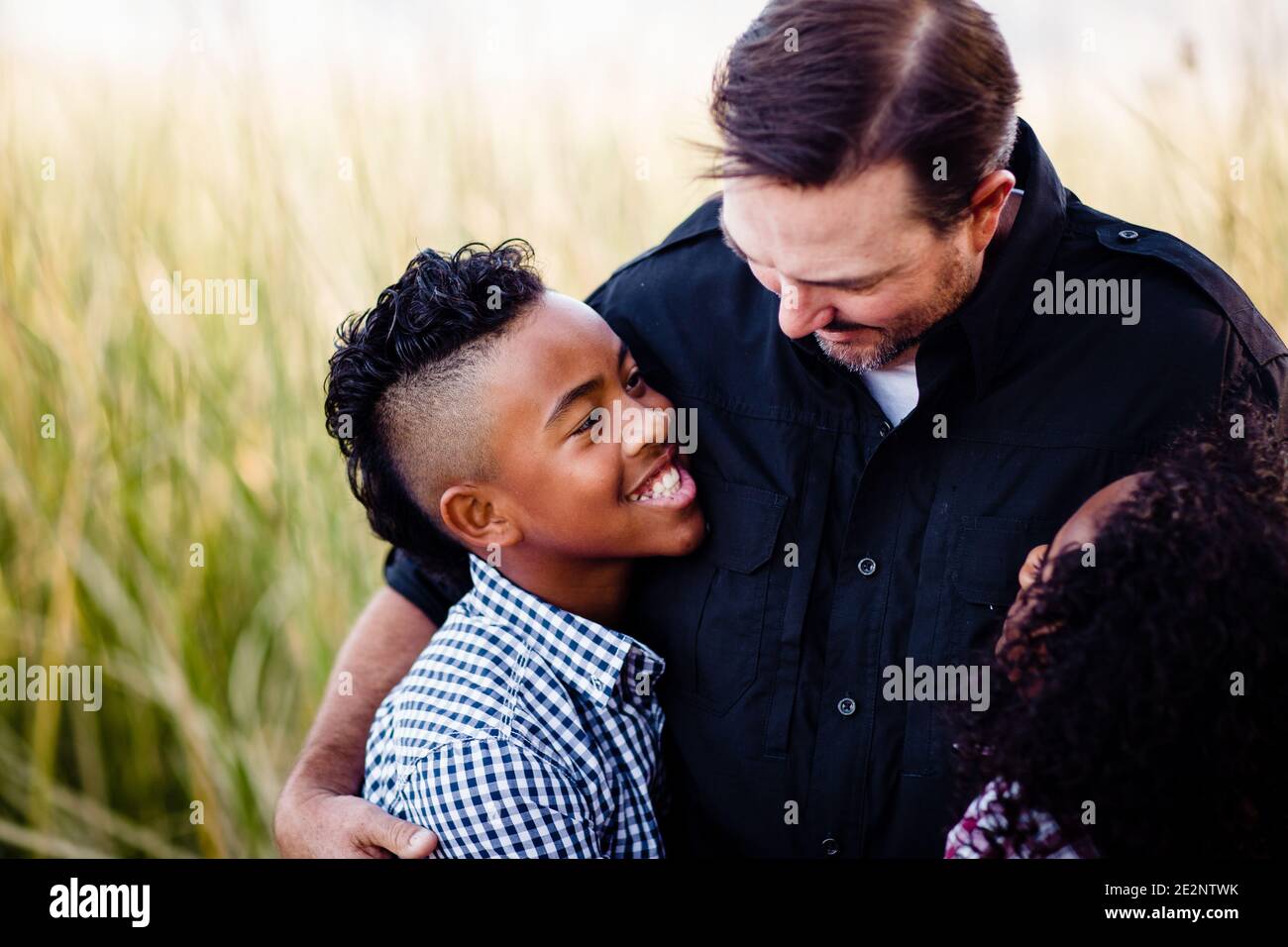 Father & Sons Embracing at Park in Chula Vista Stock Photo - Alamy