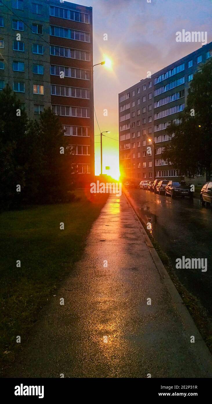 sunset between apartments on sidewalk Stock Photo - Alamy