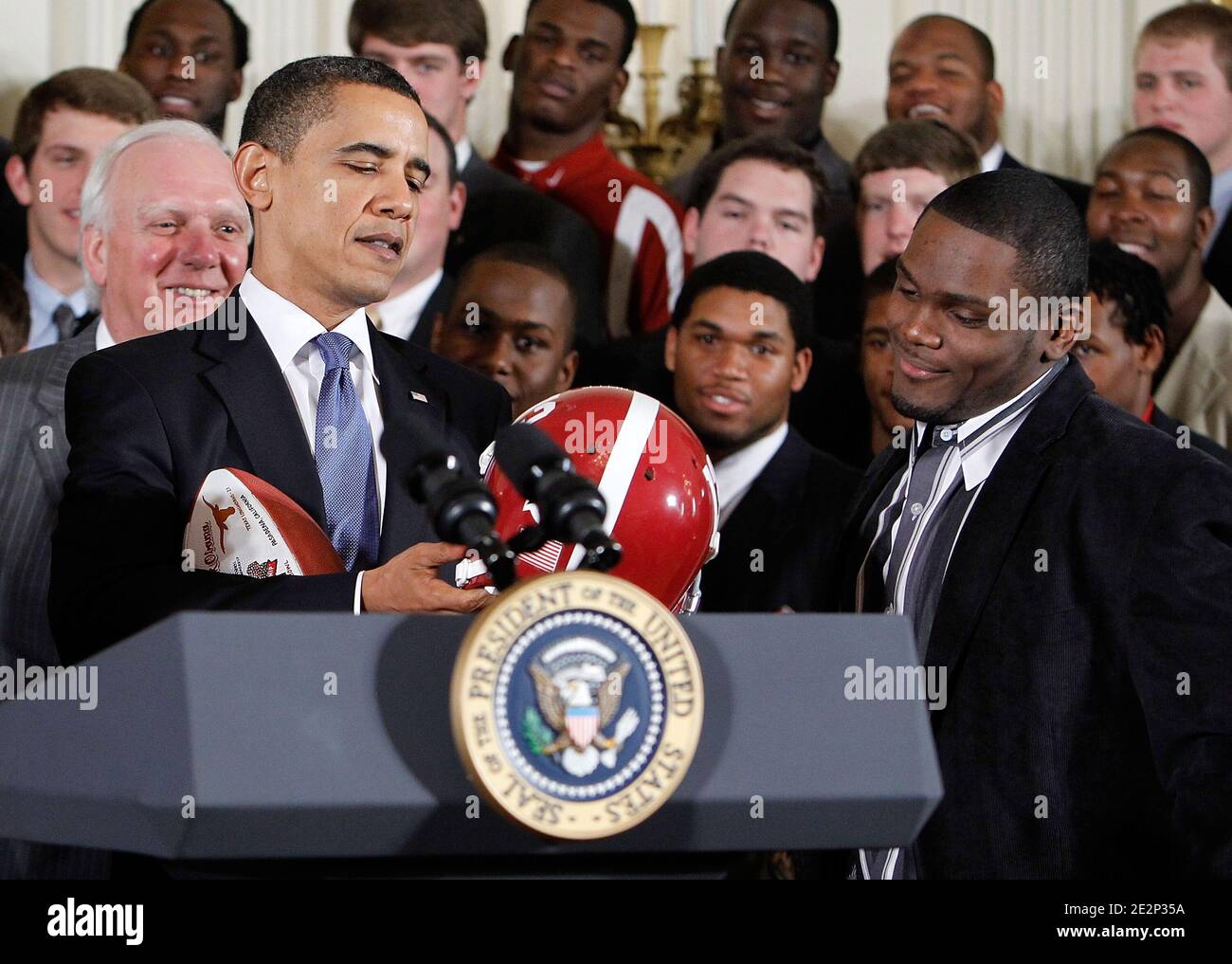 US President Barack Obama receives a football helmet during an East ...