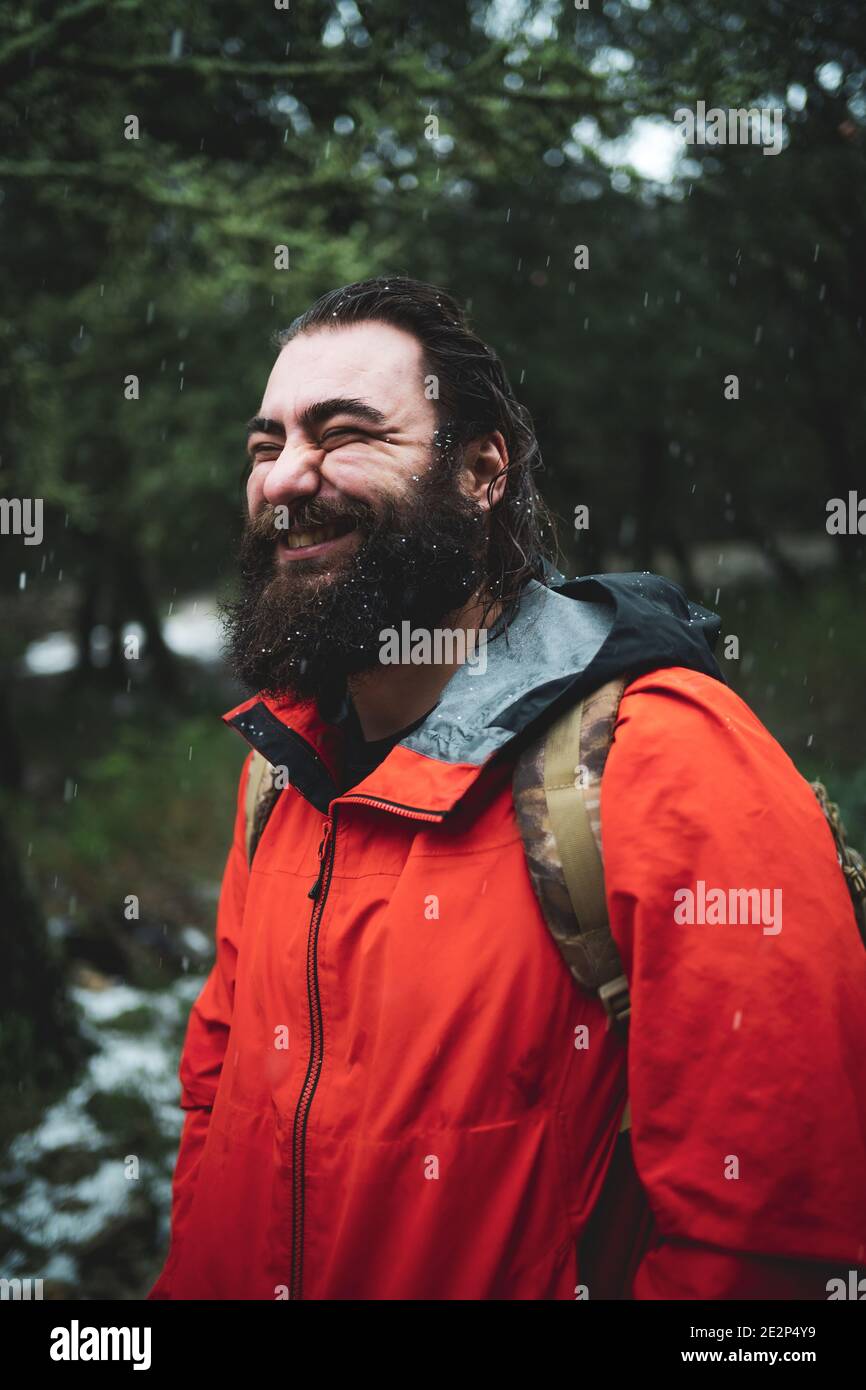 Bearded man in nature during a snowy day smiling happily Stock Photo ...
