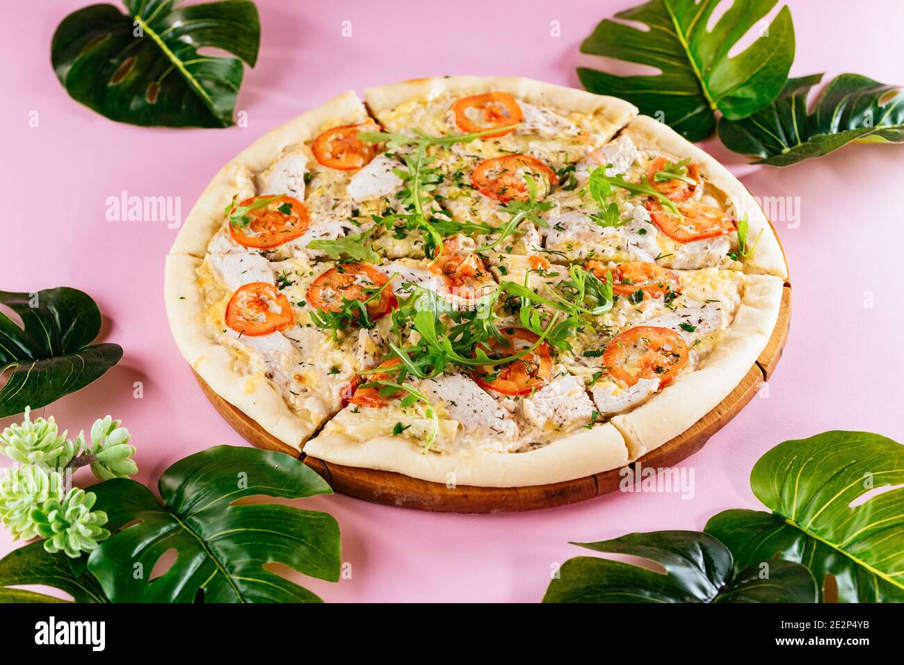 italian pizza on thin dough, pink background with tropical leaves Stock ...