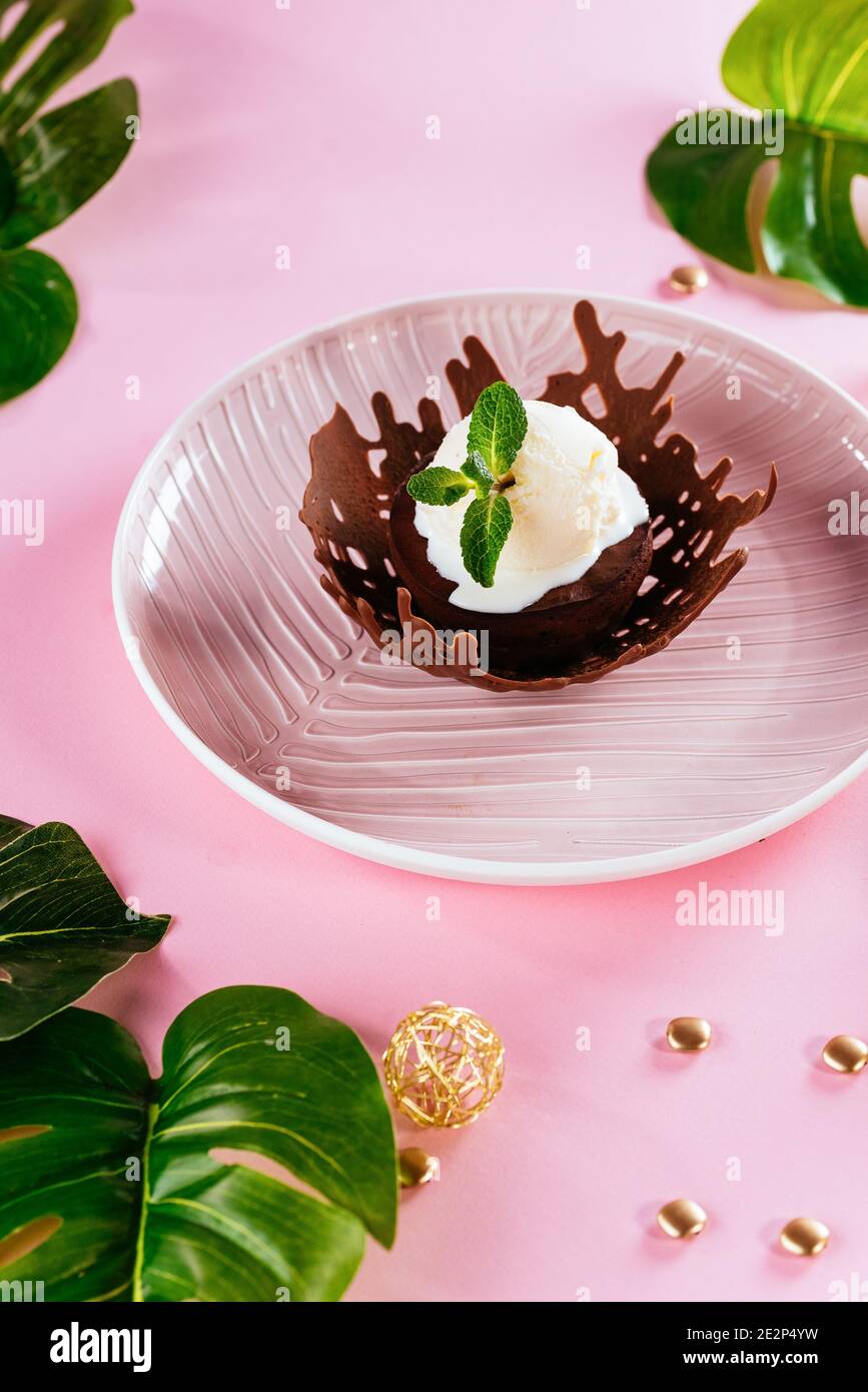 sweet dessert with a ball of ice cream on a pink background with ...