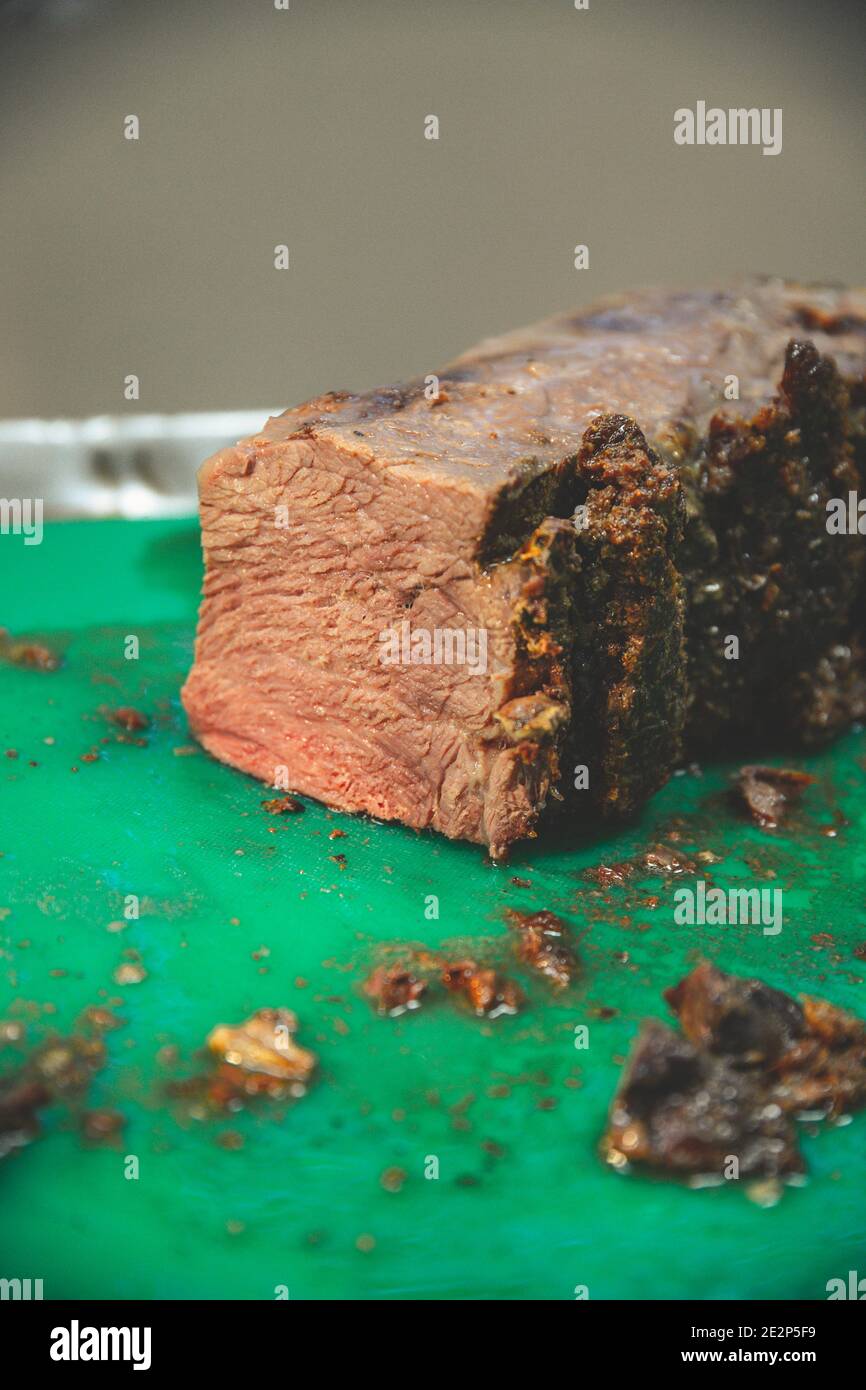 Vertical shot of cut fresh beef on board - preparation for massive ...