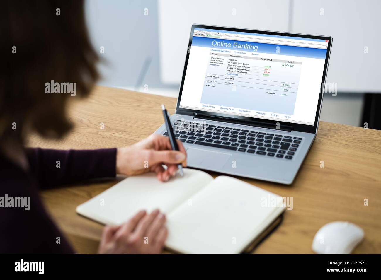 Checking Online Savings Bank Account In Office Stock Photo - Alamy