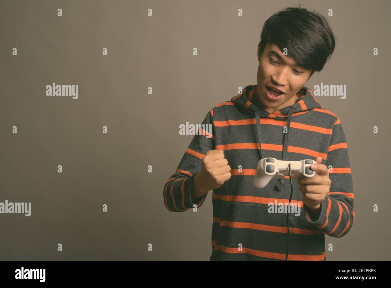 Asian guy smiling playing hi-res stock photography and images - Alamy