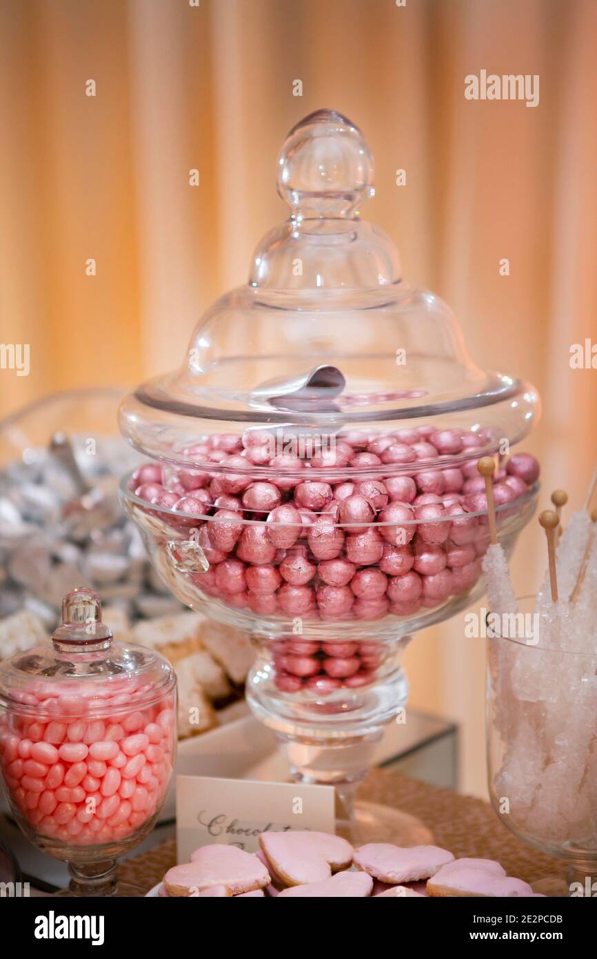 Candy jars filled with jelly beans and pink foil wrapped chocolate ...