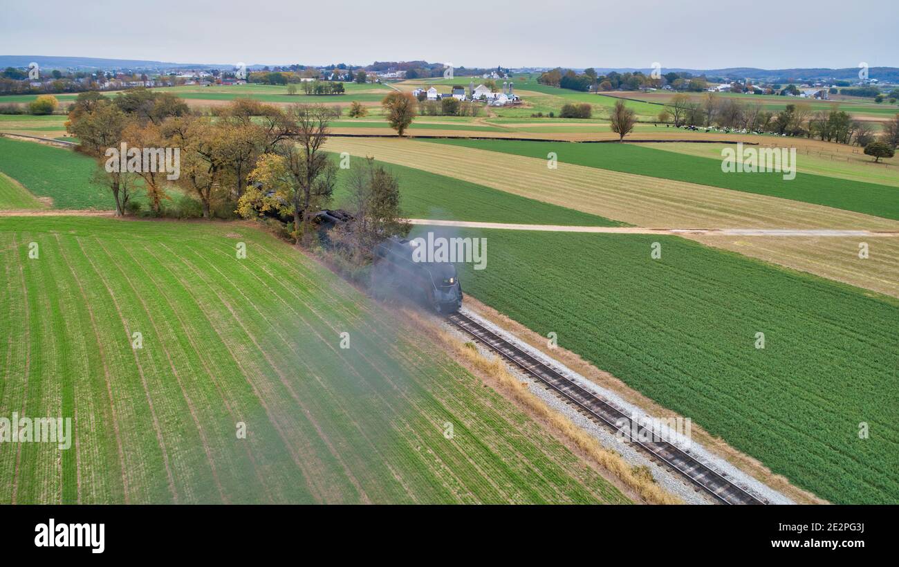 Aerial View of a Restored Antique Steam Locomotive Pulling a Caboose on ...