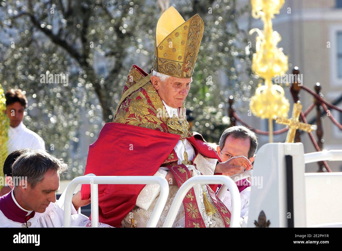 Pope Benedict XVI is helped during the Palm Sunday mass in Saint Peter ...