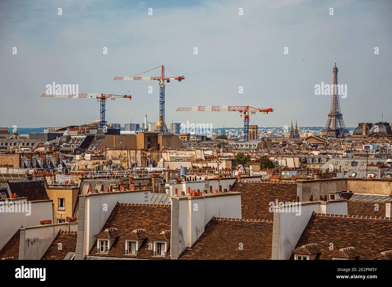 Close-up of buildings rooftops, cranes and Eiffel Tower on the horizon ...