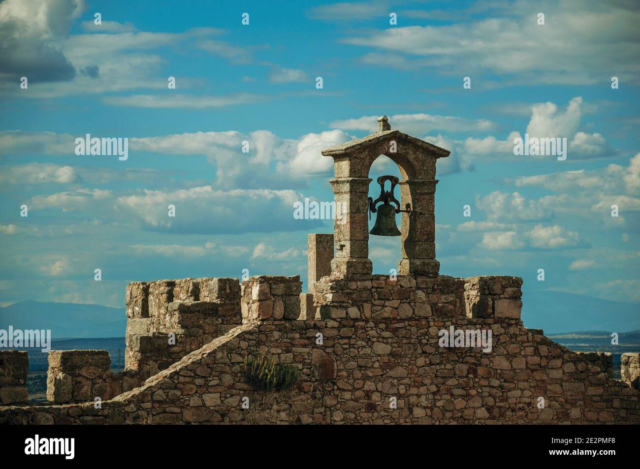 Bell on top of thick stone wall with crenels and merlons at the Castle ...