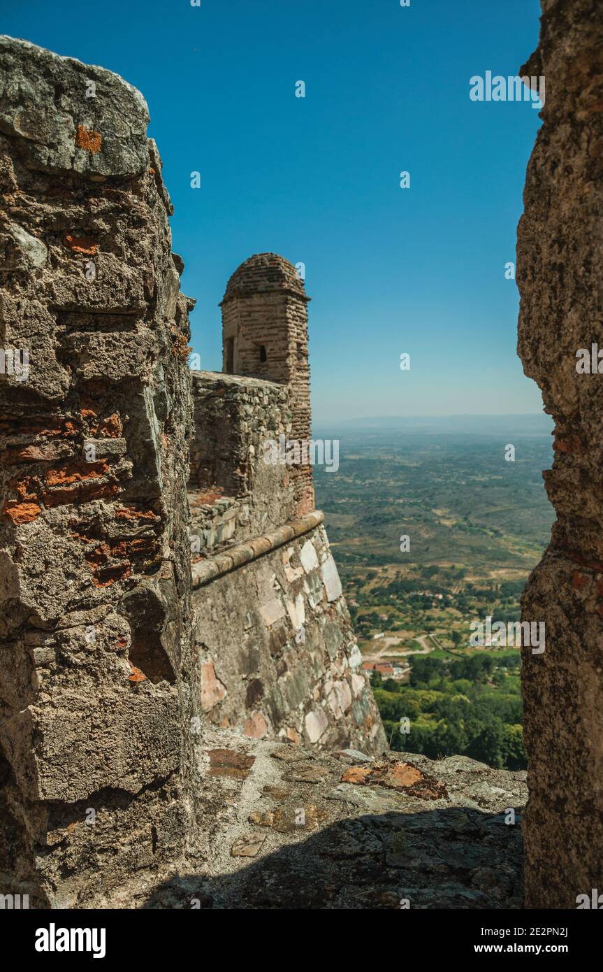 Stone wall and watchtower over cliff with hilly landscape seen by ...