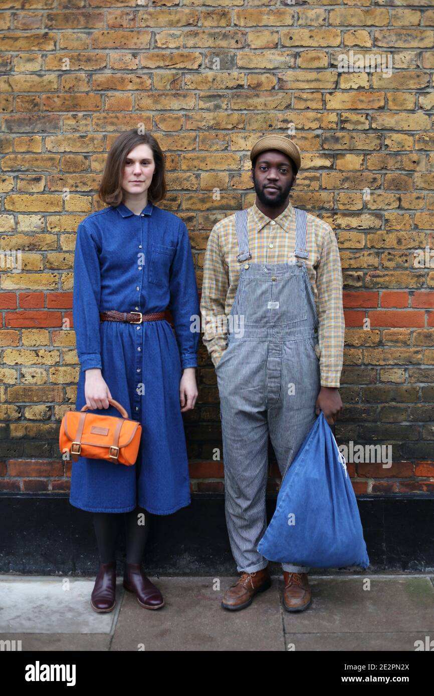 Multiracial stylish couple in denim clothes posing on a background of a ...