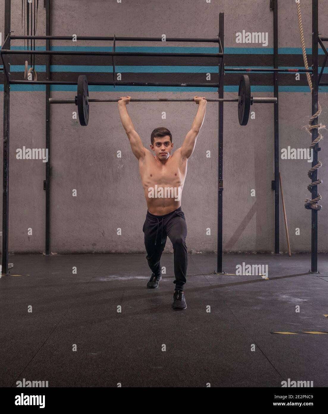 Boy lifting weight at gym, fitness concept Stock Photo - Alamy
