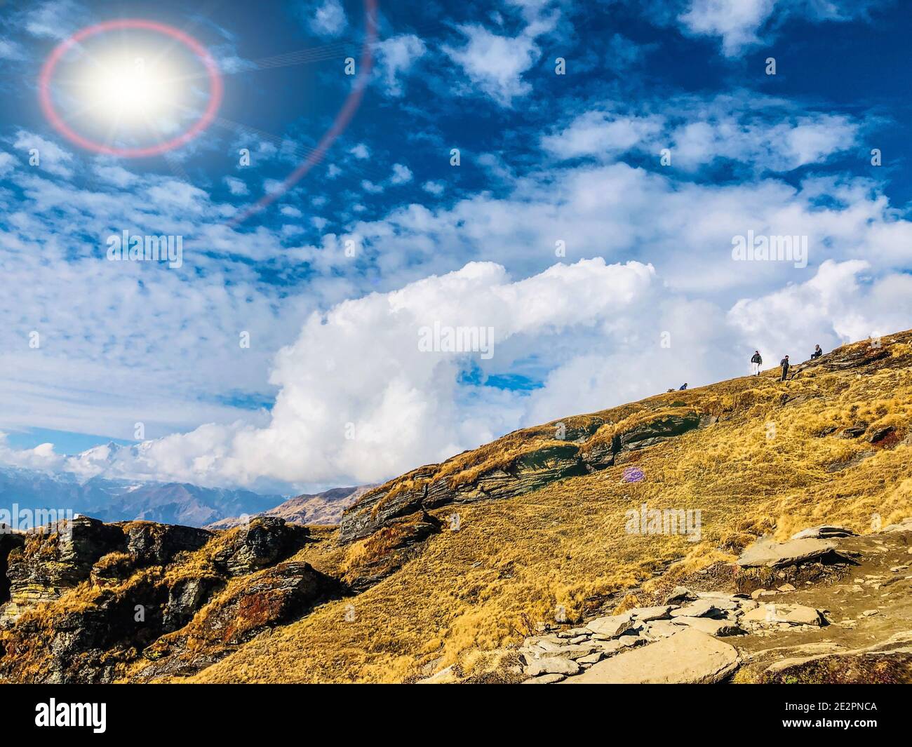 Beautiful scenery of people working on the hill under the cloudy sky ...