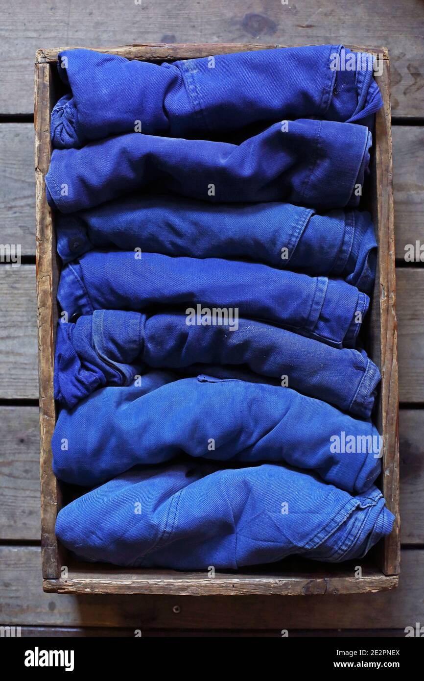 wooden box with different blue denim clothes Stock Photo - Alamy