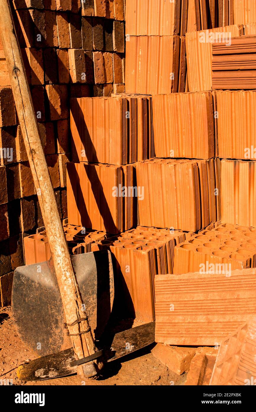 A shovel and a hoe near piles of blocks and bricks Stock Photo - Alamy