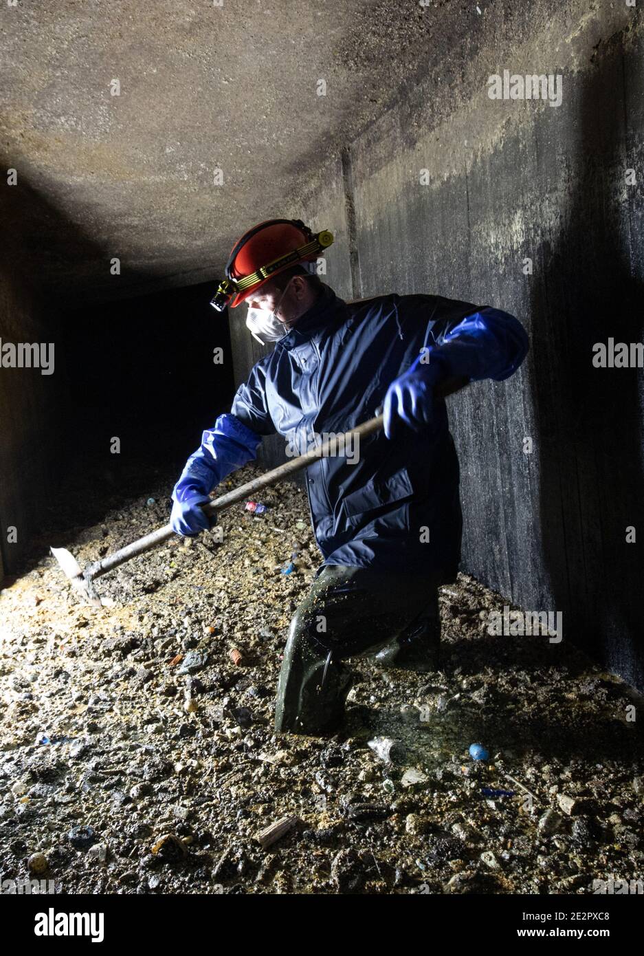 Hamburg, Germany. 14th Jan, 2021. A sewer worker stands in remnants of ...