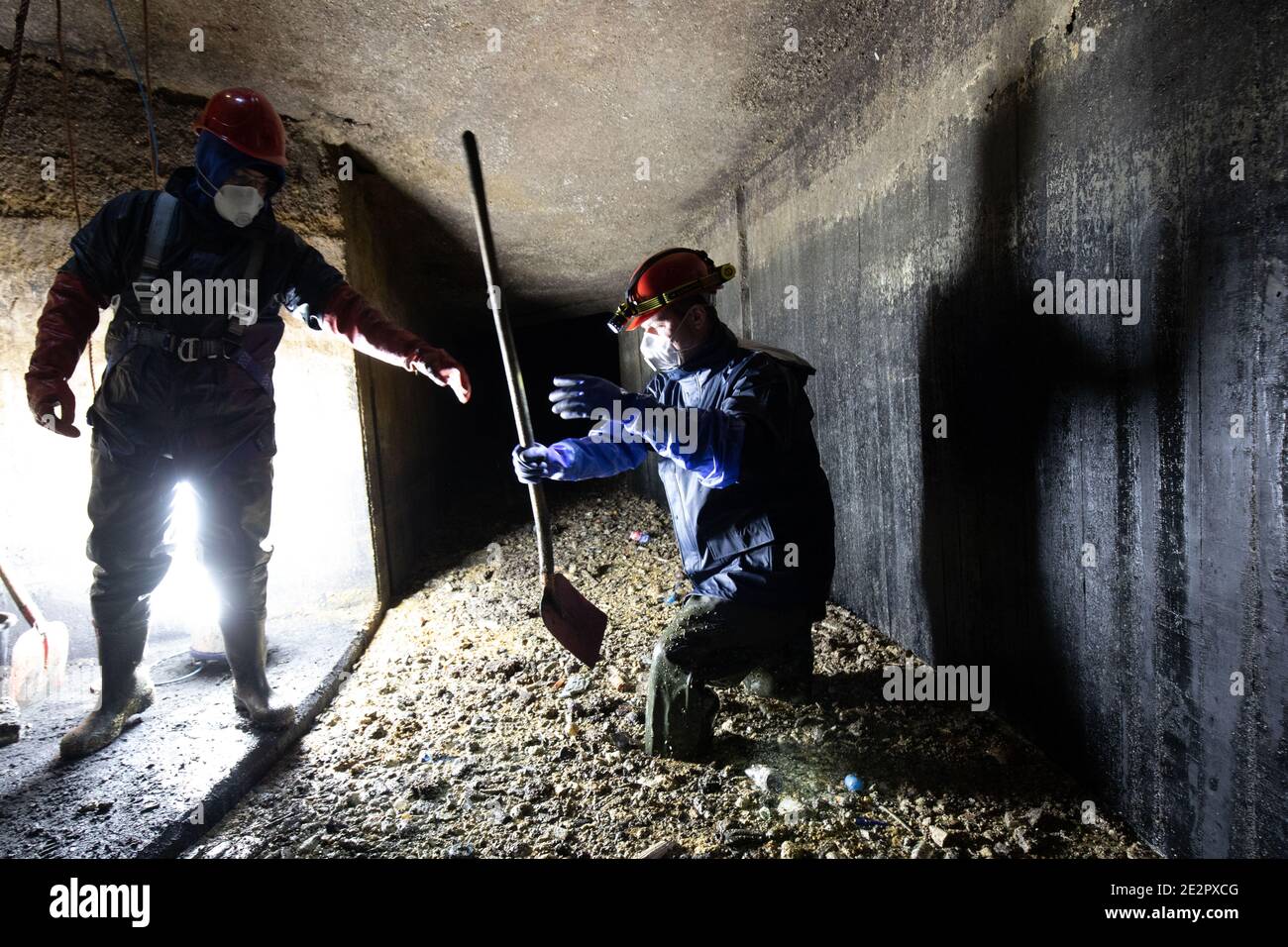 Hamburg, Germany. 14th Jan, 2021. Sewer workers stand in residues of ...