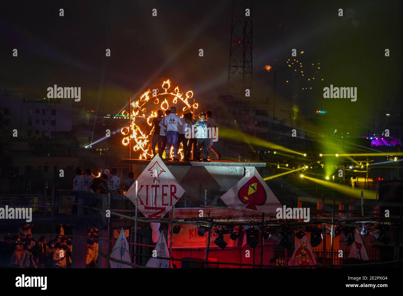 Bangladeshi people set up party lights and perform dance on a rooftop ...