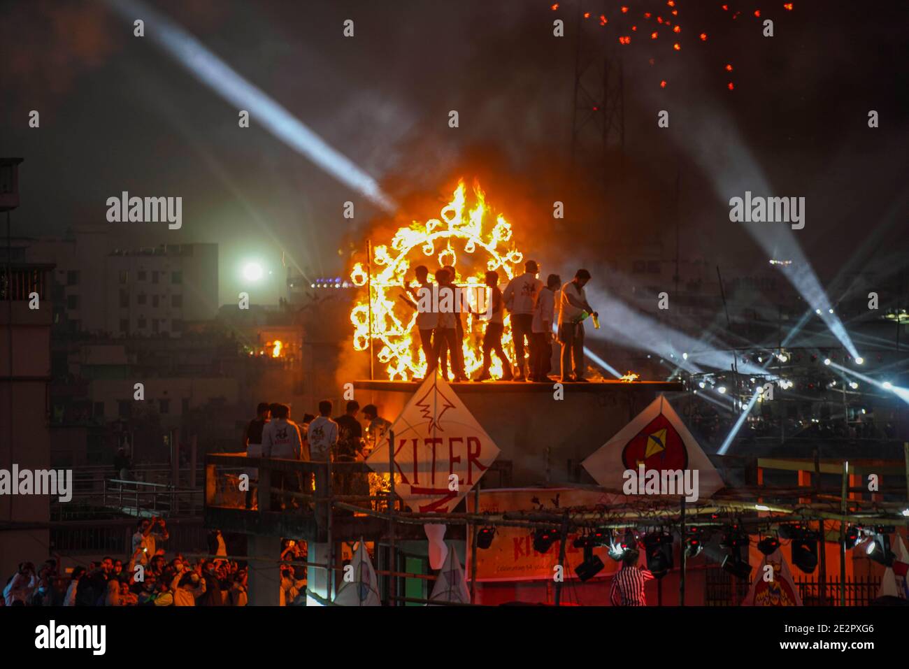 Bangladeshi people set up party lights and perform dance on a rooftop ...