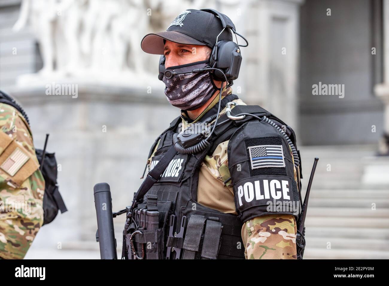 Capitol Police stand guard behind orange barricades at the Pennsylvania ...