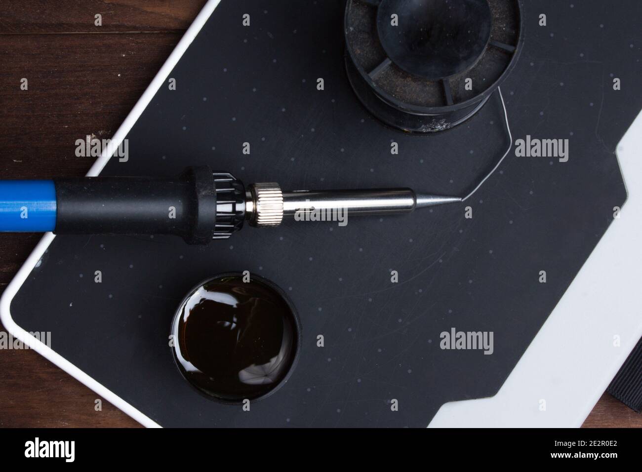 Soldering tools. Soldering iron, and rosin, on a black background Stock ...