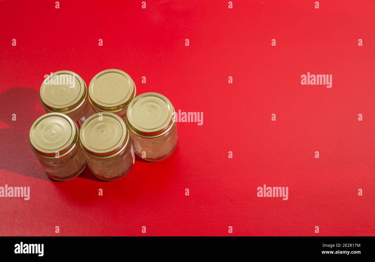 High angle shot of a bunch of glass jars on a red surface Stock Photo ...