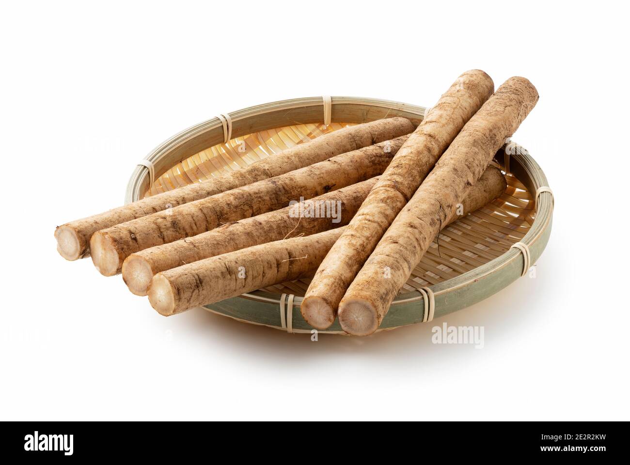 Burdock in a bamboo basket on a white background Stock Photo - Alamy