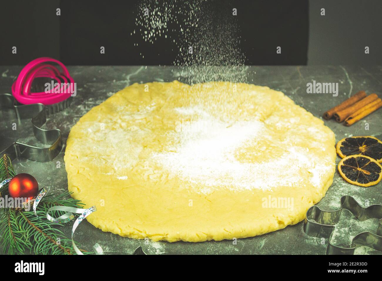 Pastry dough rolled out on the table. The raw dough is rolled out on a ...