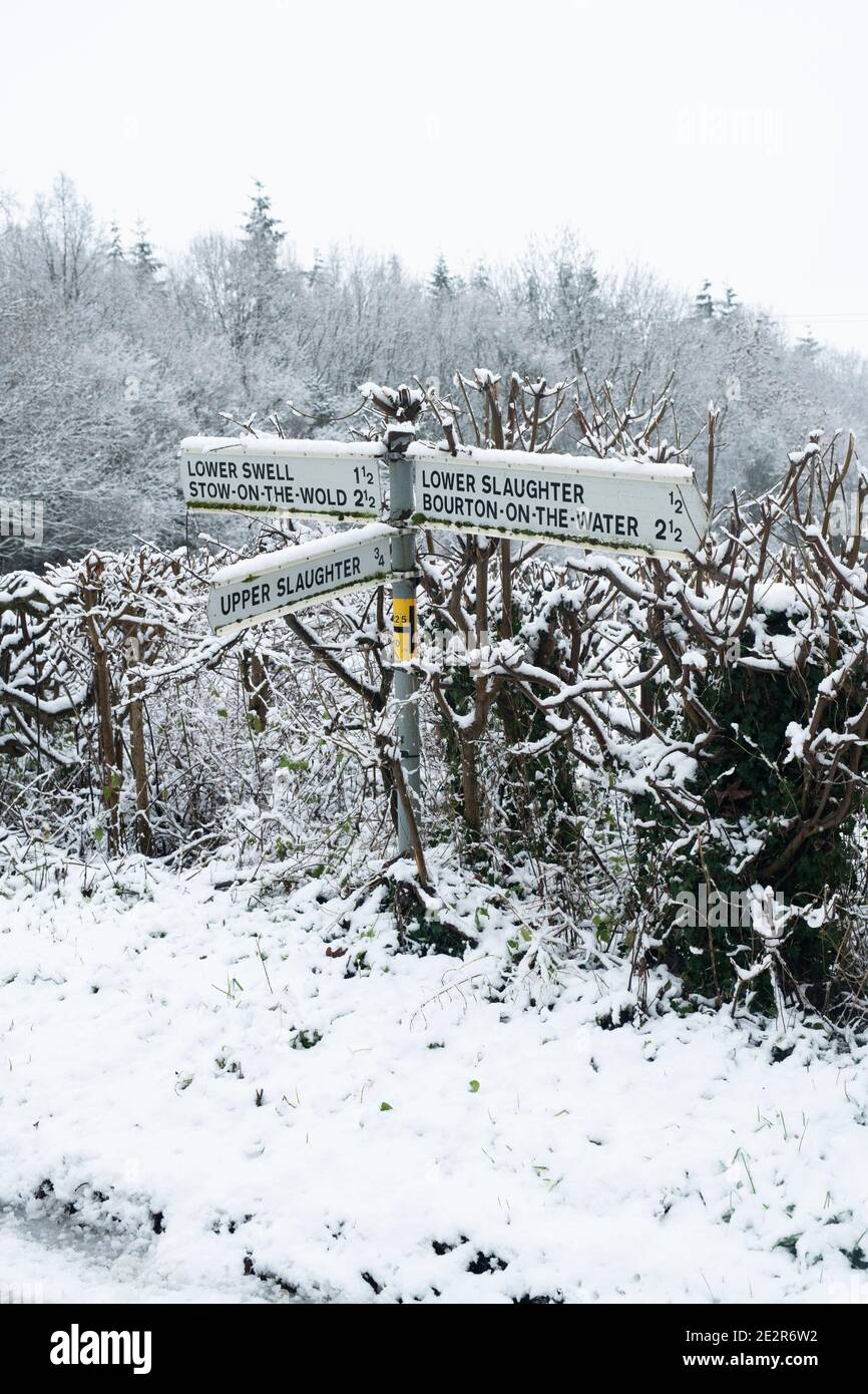 Upper and Lower Slaughter signpost in the december snow. The Slaughters ...