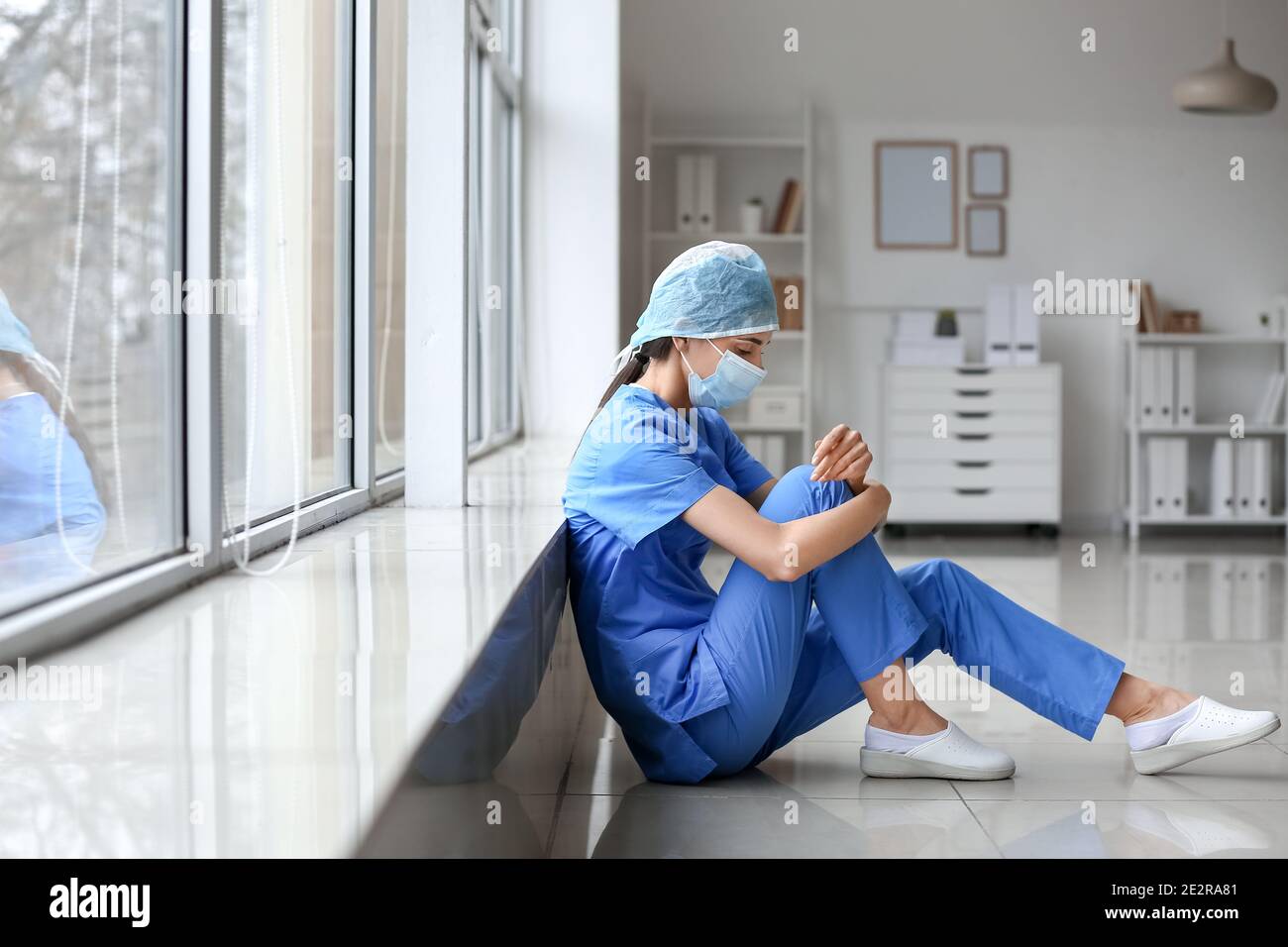 Stressed female surgeon in clinic Stock Photo - Alamy