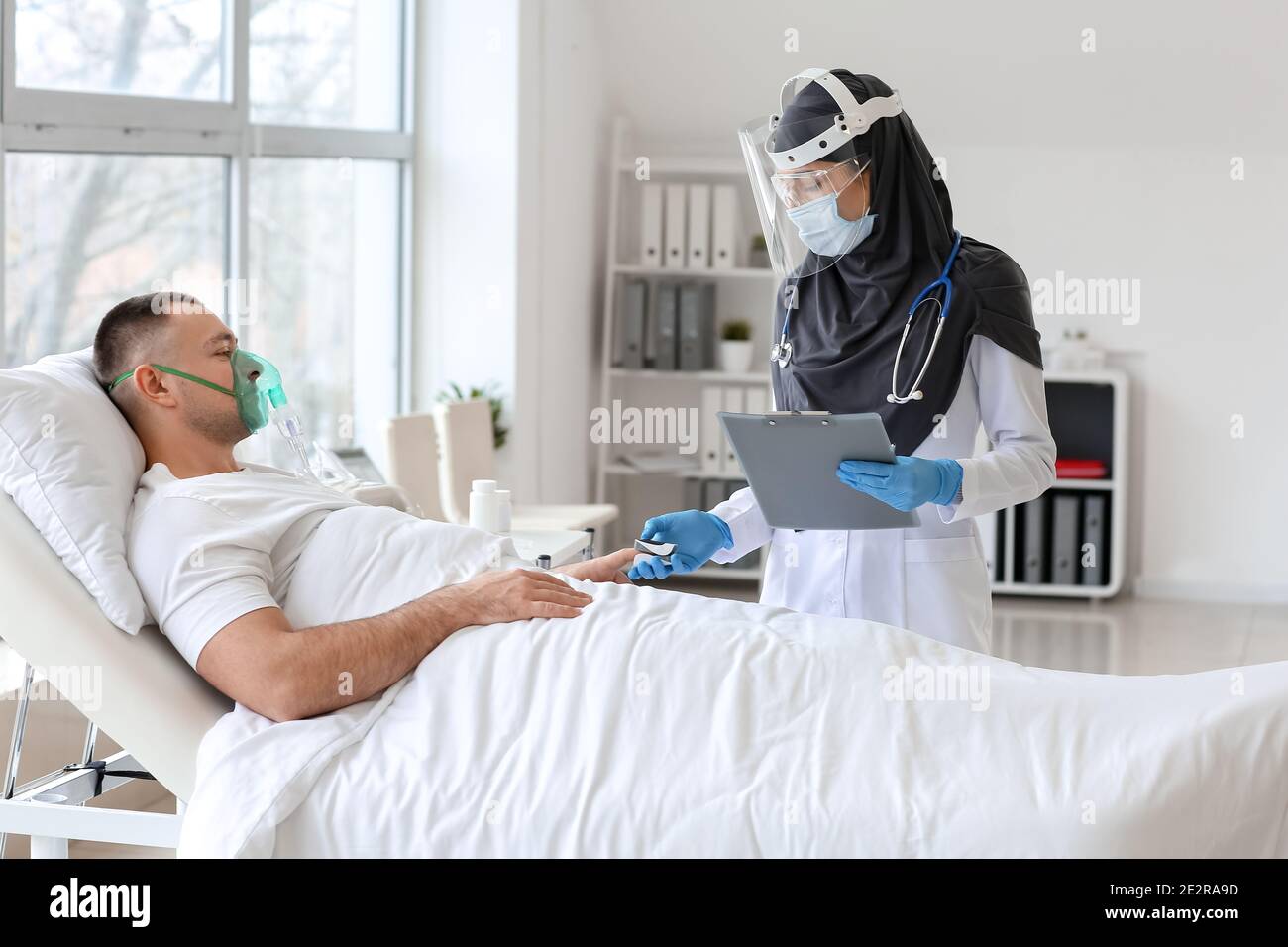 Doctor measuring oxygen saturation level of patient blood in clinic ...