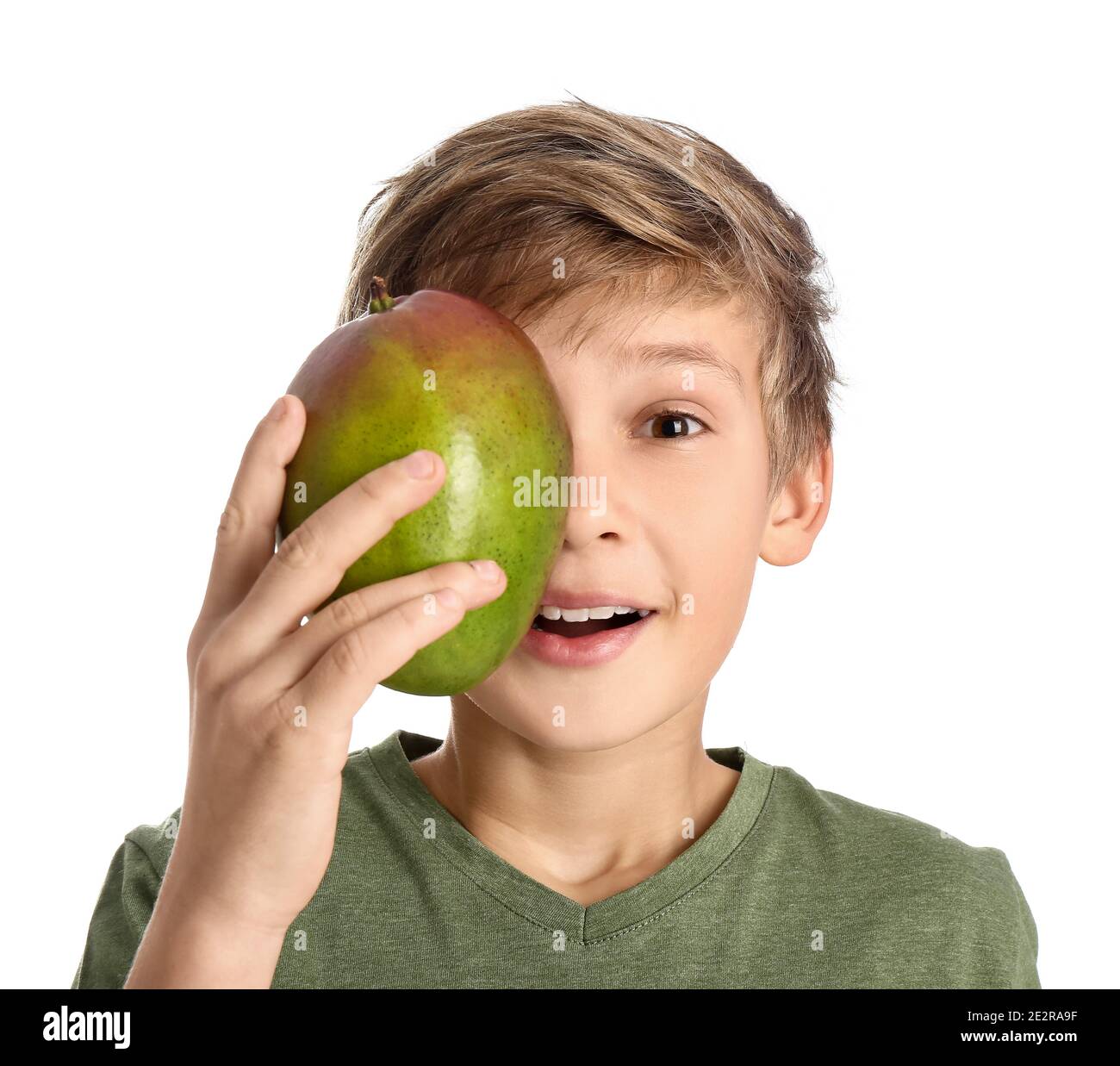 Cute little boy with fresh tasty mango on white background Stock Photo ...
