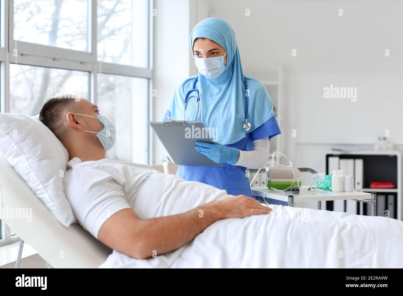 Muslim woman doctor examining patient hi-res stock photography and ...