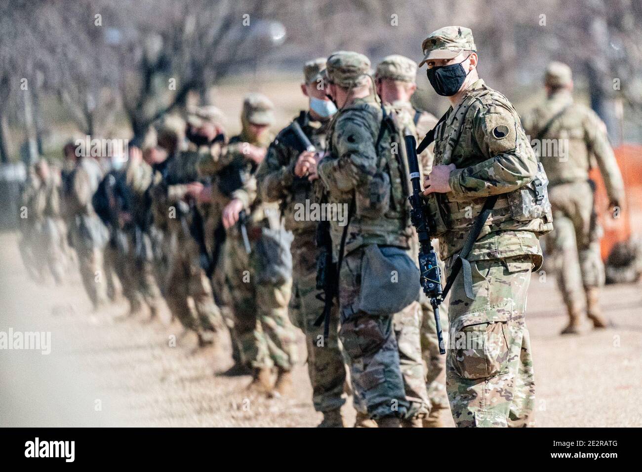 Heavily armed US National Guard troops stand at the perimeter of the ...