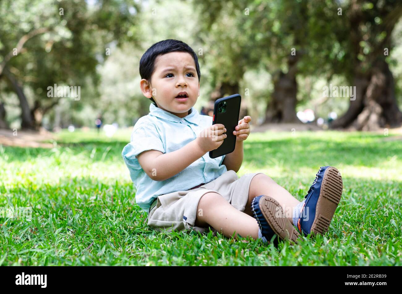 New digital technologies in the hands of a child. Little boy playing ...
