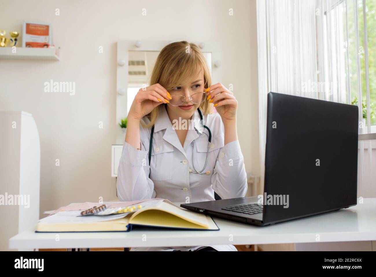 young stressed woman doctor sitting in modern office.tired doctor at ...