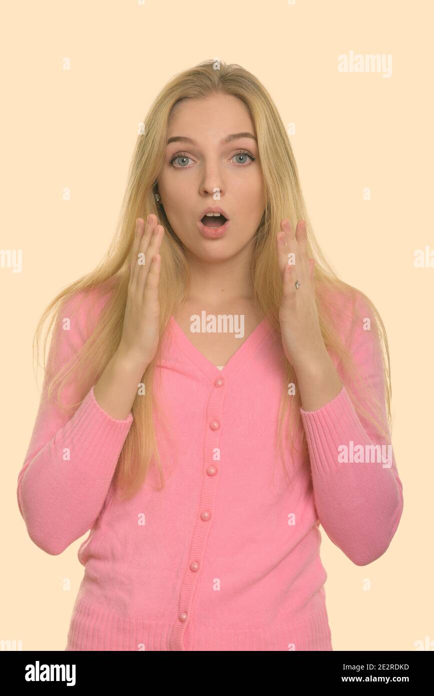 Studio shot of young beautiful teenage girl looking shocked Stock Photo ...