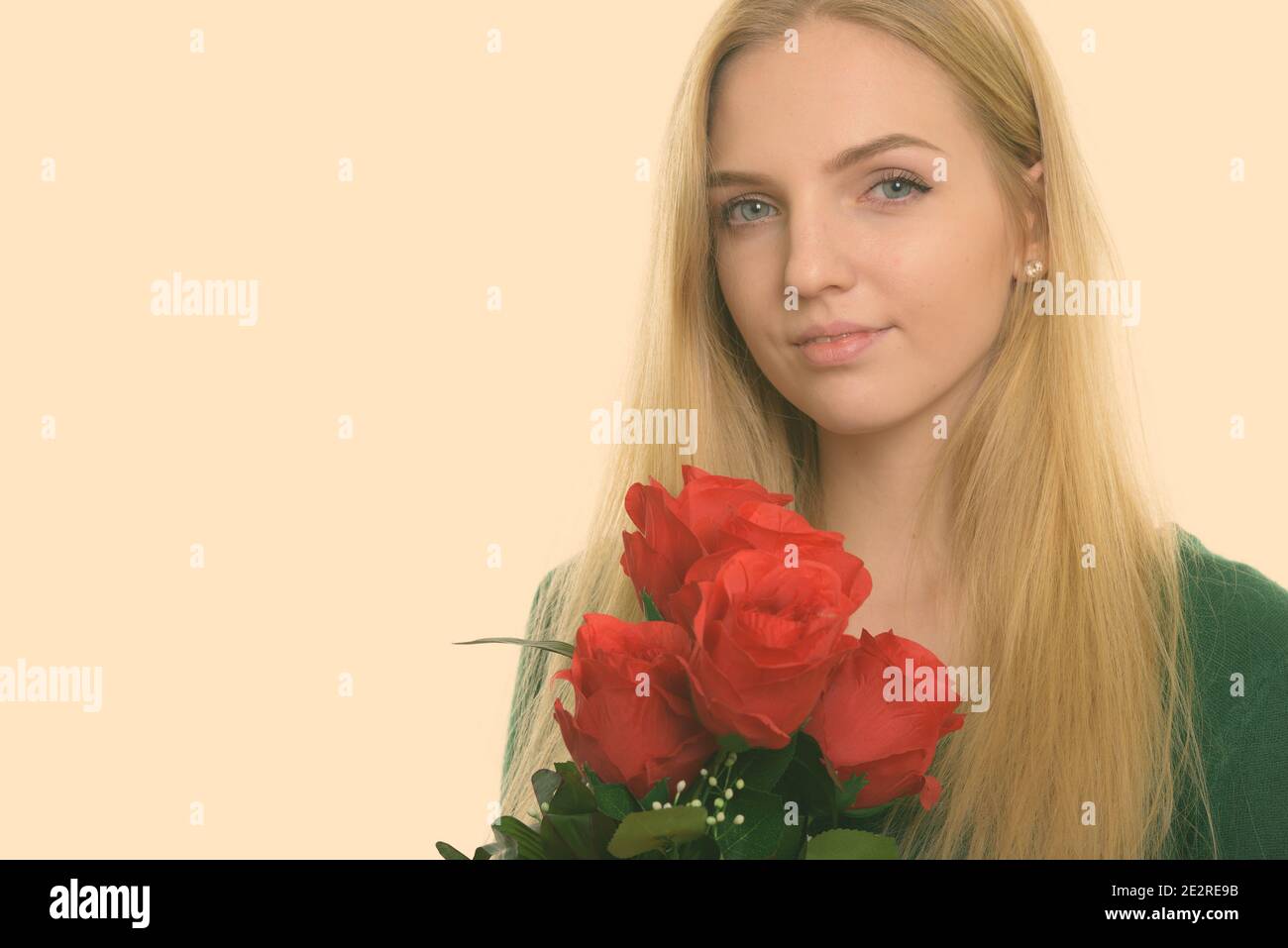 Close up of young beautiful teenage girl holding red roses ready for ...