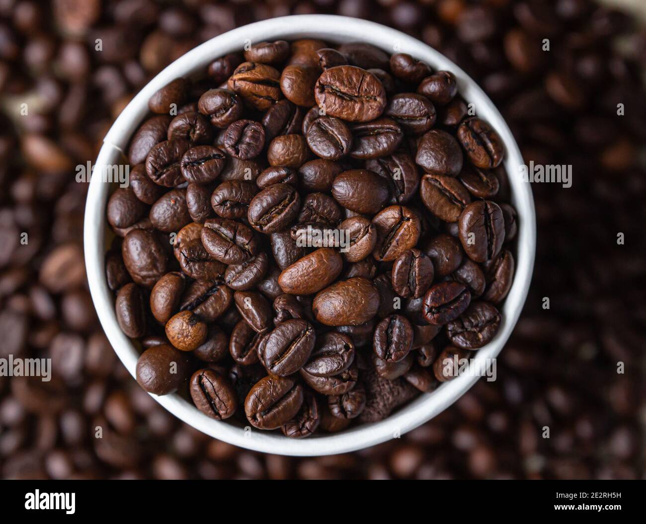 Takeaway coffee recycle cup with roasted coffee beans on coffee beans ...